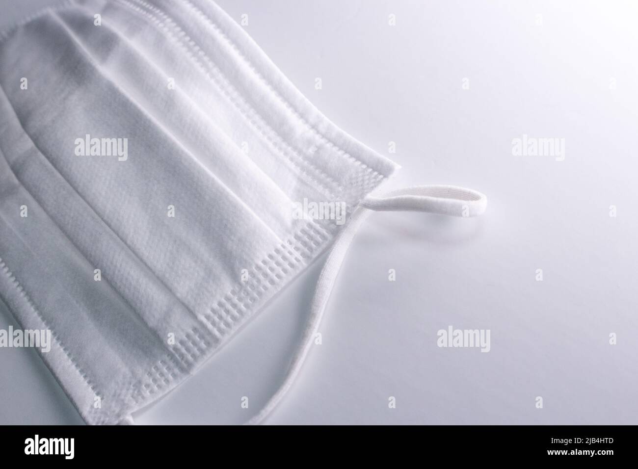 Plain white facial mask (cover) on white background Stock Photo - Alamy