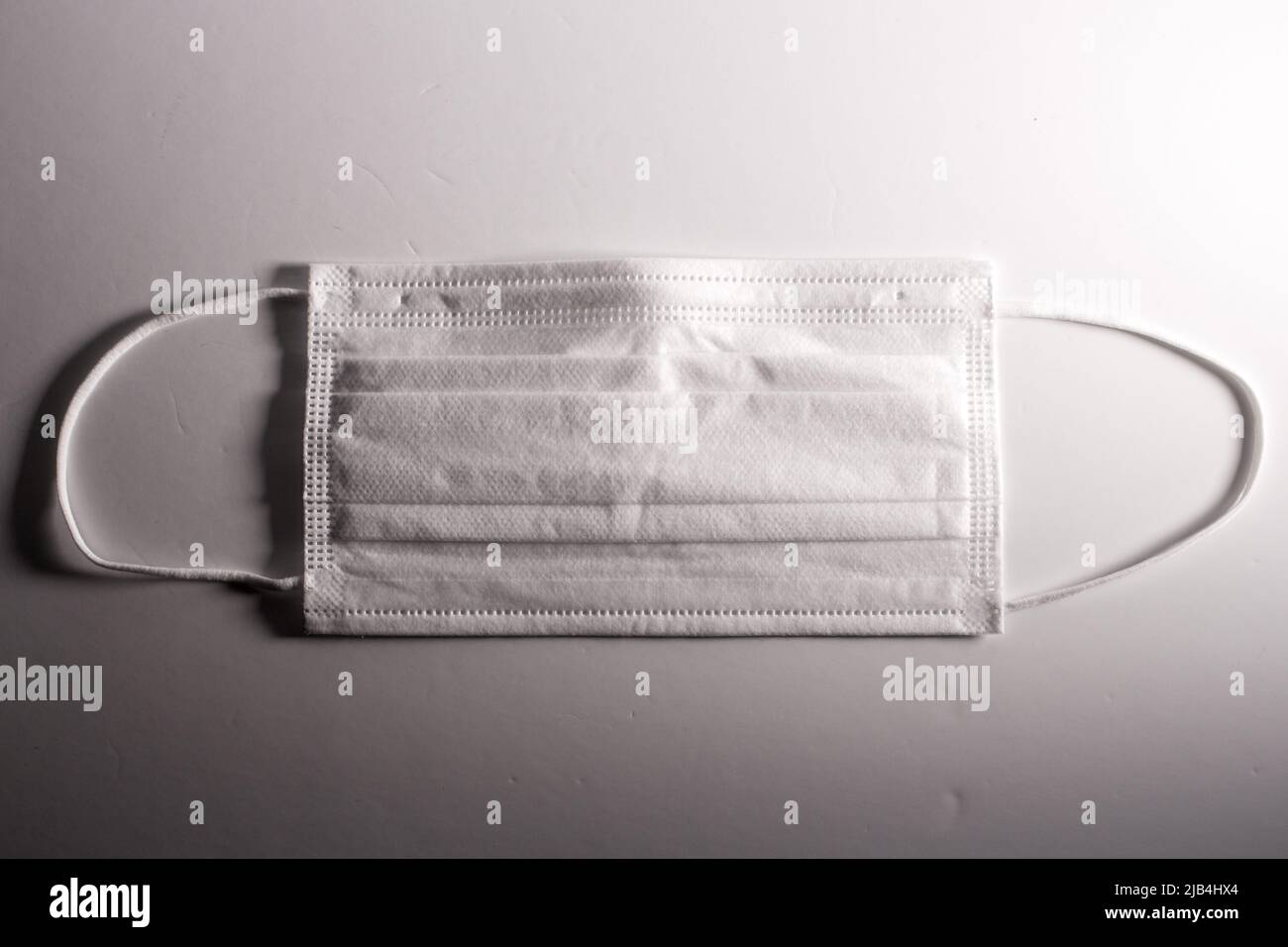 Plain white facial mask (cover) on scratched rough background Stock ...