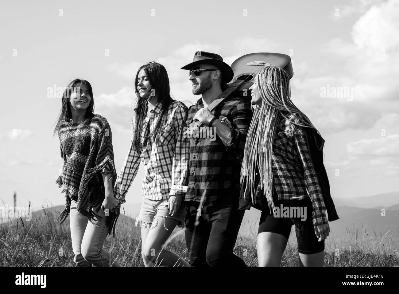 Young happy tourist on mountain enjoying. Happy young friends enjoy a ...