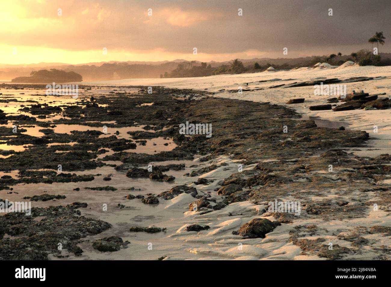 Landscape of rocky, sandy beach that is captured before sunset time in ...
