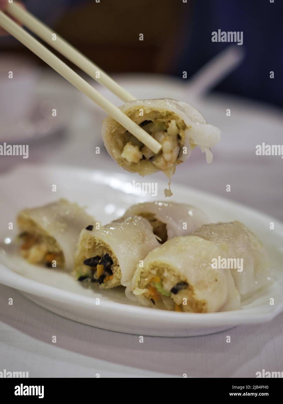 Delicious Chinese dim sum in a chinese restaurant, chopsticks holding a ...