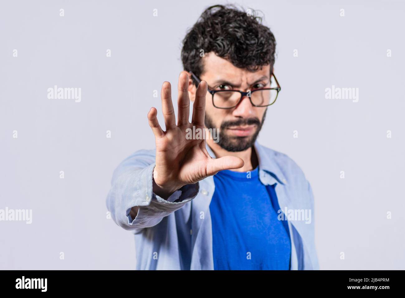 Serious young man stop sign with palm, caucasian man stop sign with ...