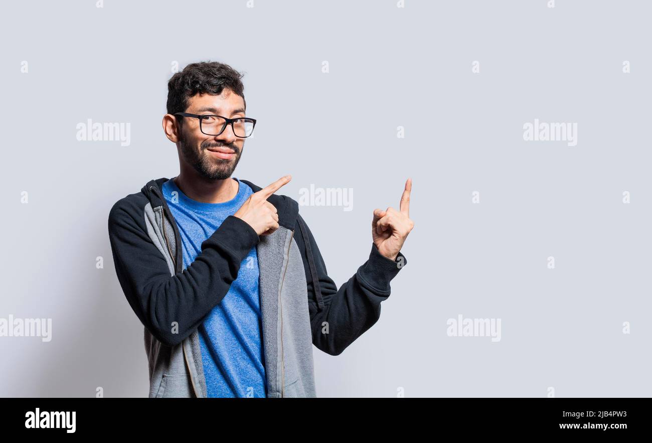 Smiling person pointing fingers to the side, smiling man recommending ...