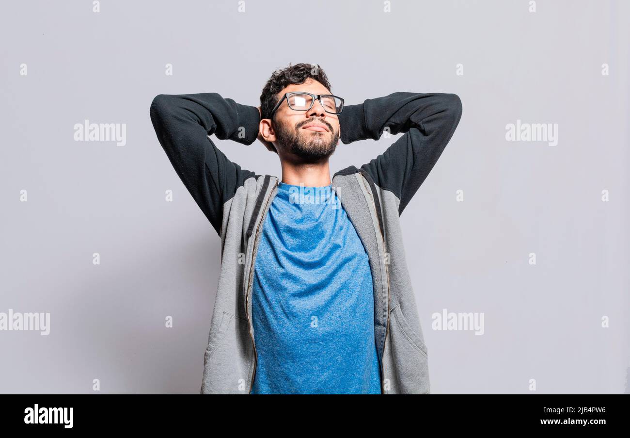Relaxed person with closed eyes with hands behind his head isolated ...