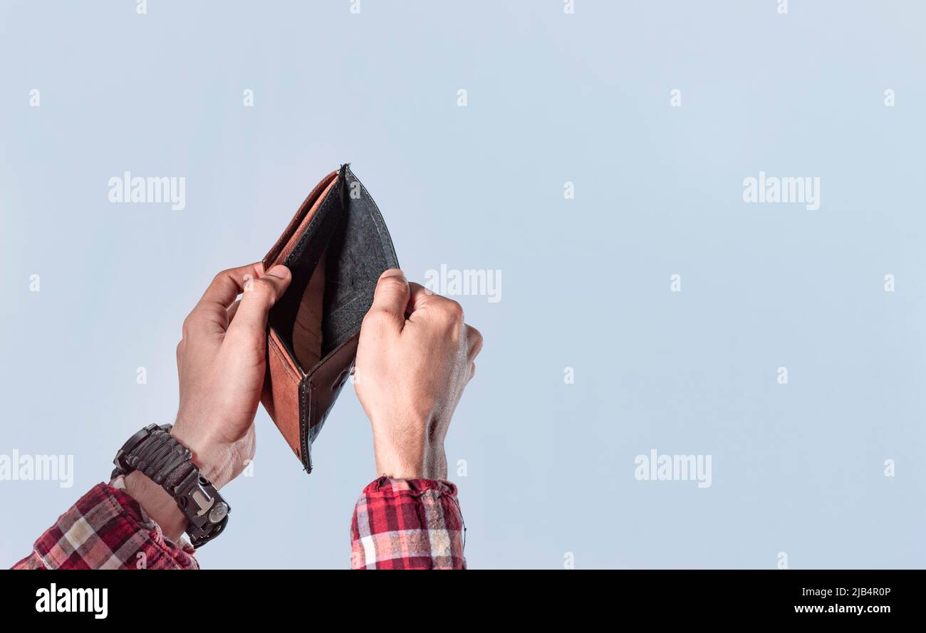 Concept of an empty wallet, hand opening empty wallet on isolated ...