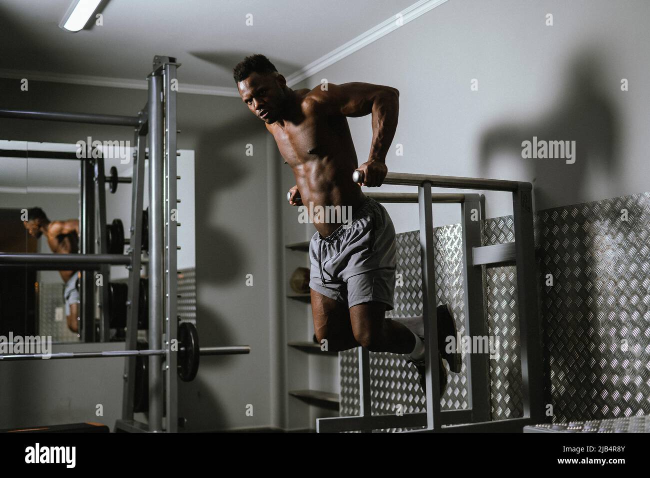 Handsome afro american man doing parallel bars exercise in gym Stock ...