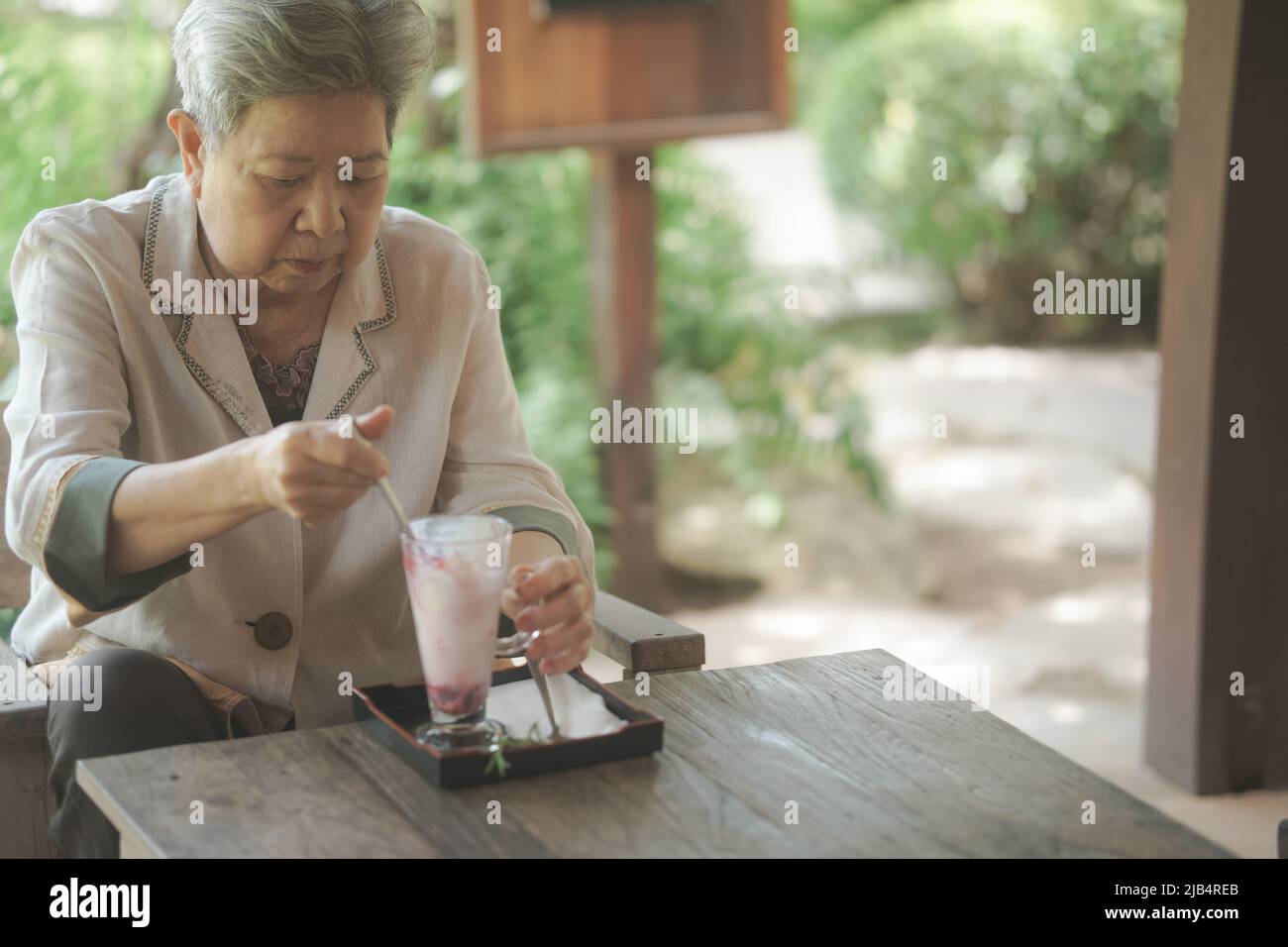 Elderly woman eating ice cream hi-res stock photography and images - Alamy