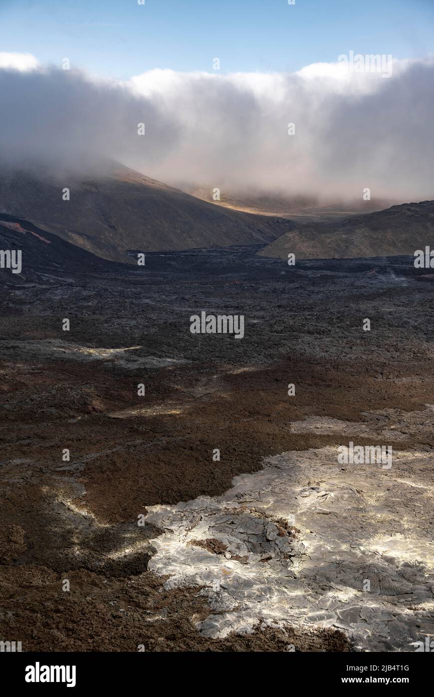 Lava fields with sulphur deposits between hills, volcanic eruption ...