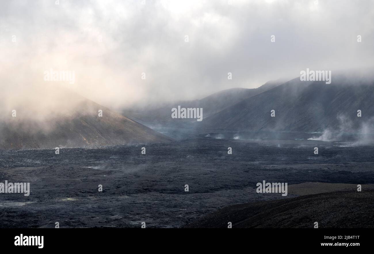 Steaming lava fields between hills, volcanic eruption, active table ...