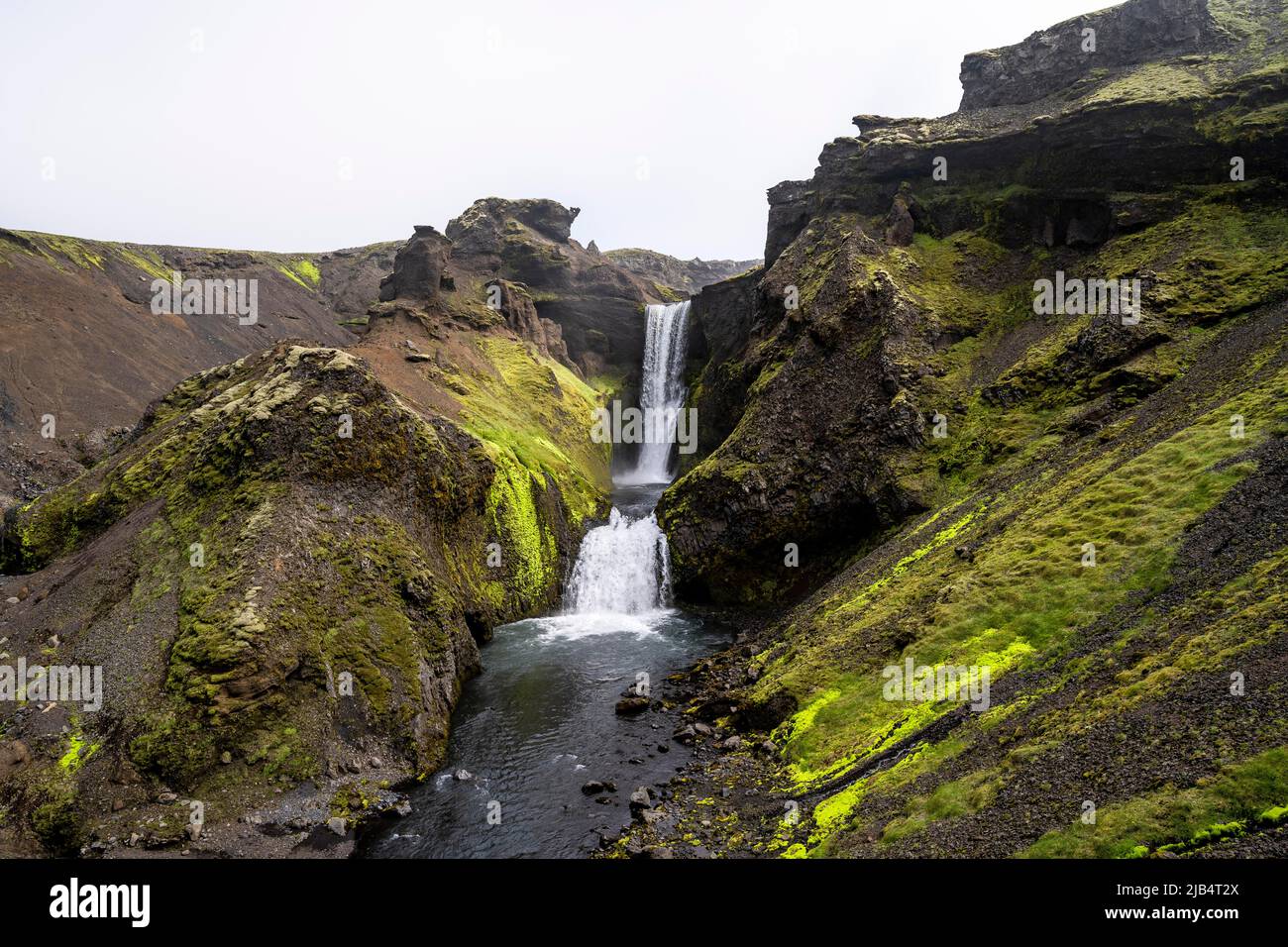 Waterfall, Ragged canyon overgrown with moss, River Skoga, Landscape at ...