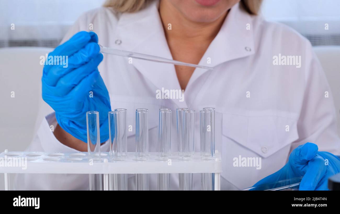 professional scientist laboratory assistant takes and examines samples ...