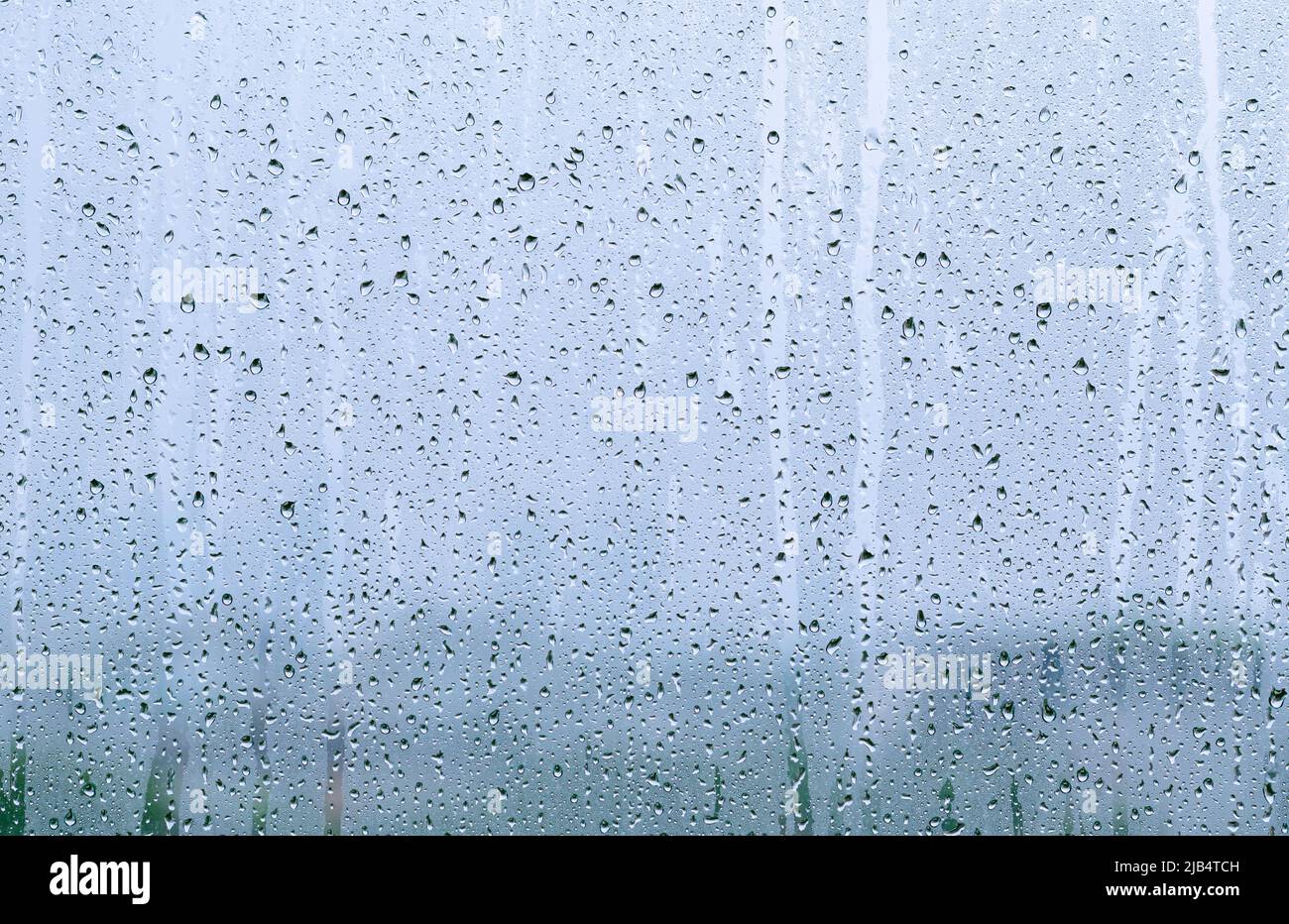 Rain drop on glass window at day time in monsoon season with blurred ...