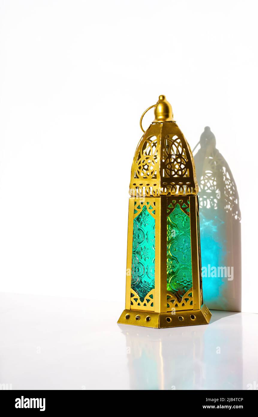 Golden lantern with shadow from sun light on white background Stock ...