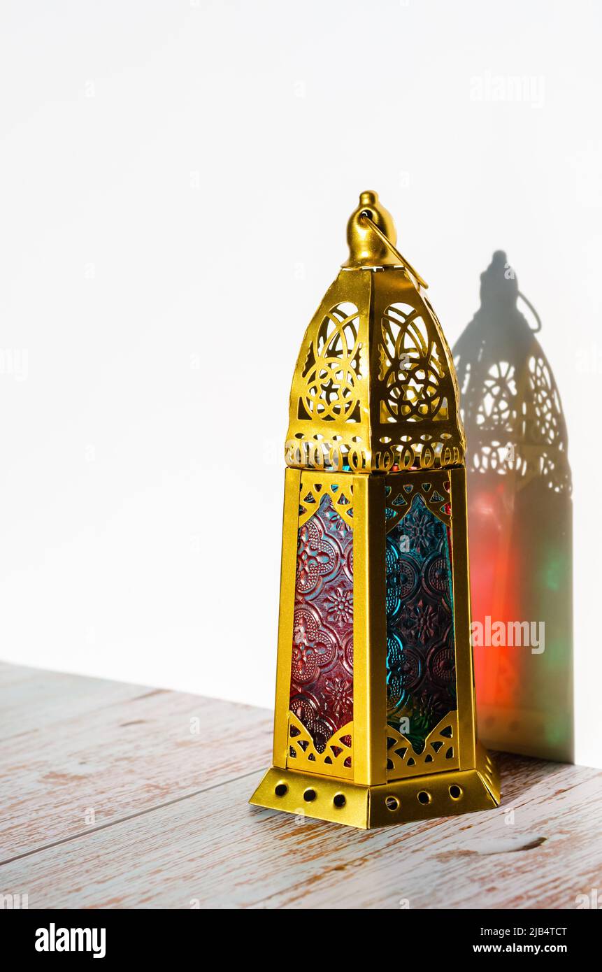 Golden lantern with shadow from sun light on white background Stock ...