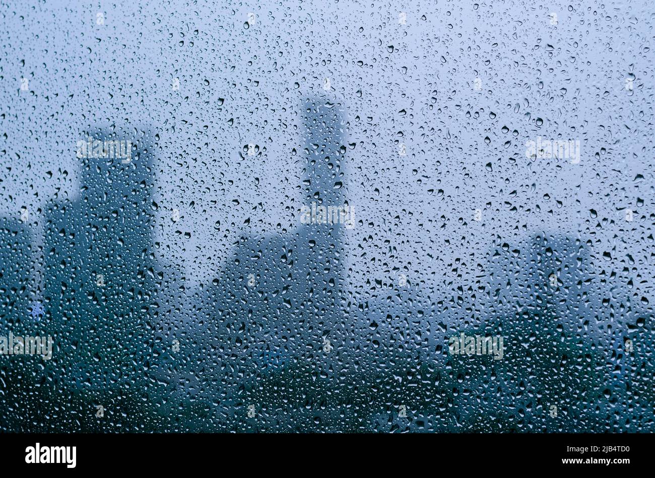 Rain drop on glass window at day time in monsoon season with blurred ...