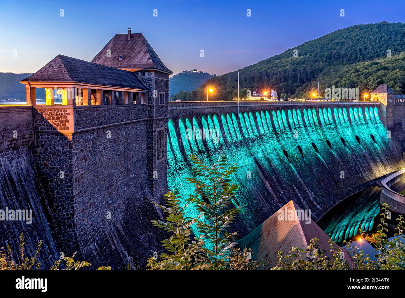 Dam in evening light, bright cyan illuminated, dam wall of Edersee ...
