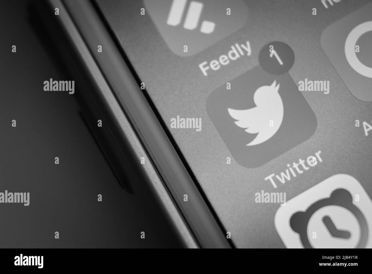 Twitter app with badge 1 on iPhone in monochrome. Twitter is US ...