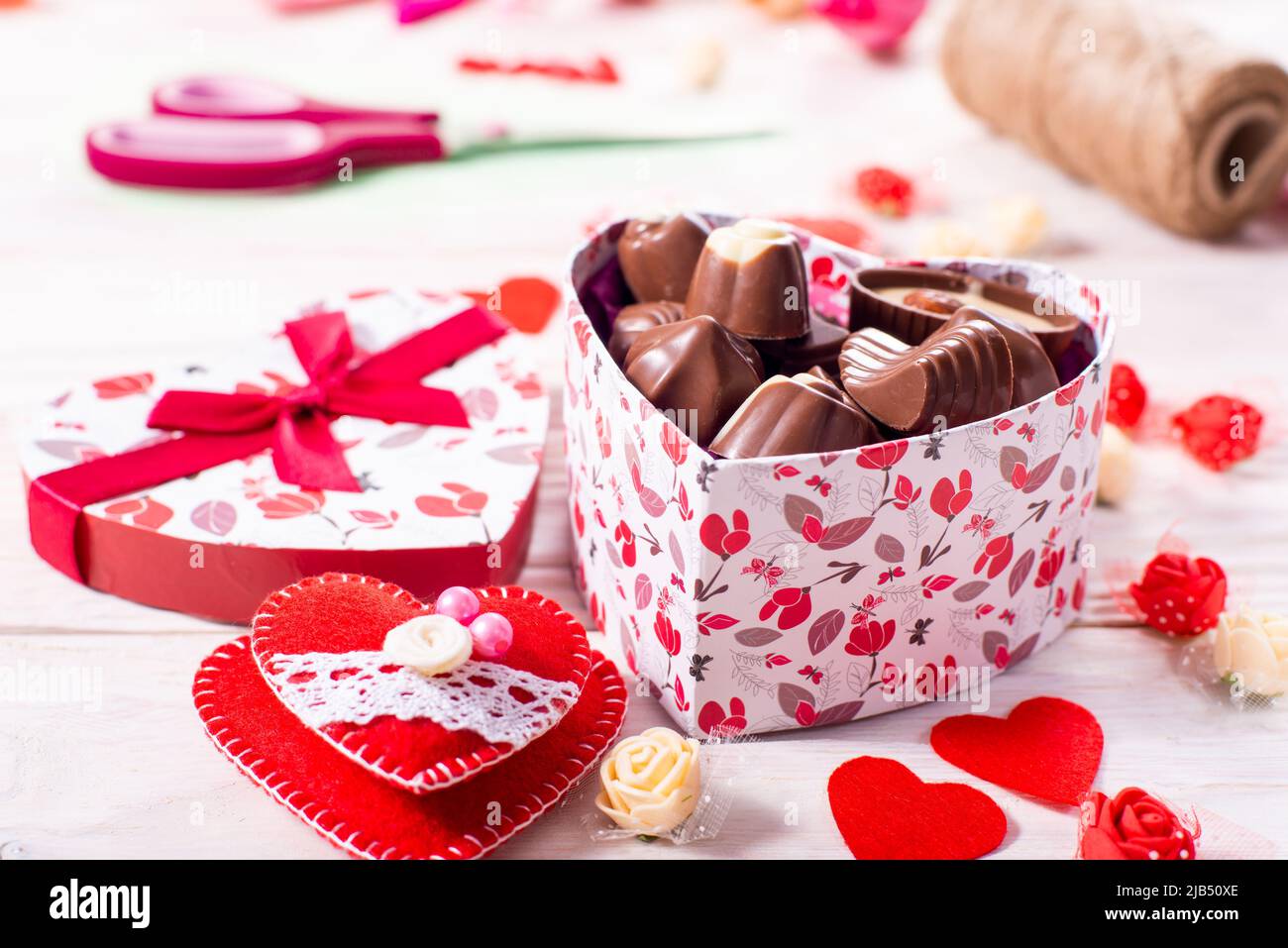 Chokolate box in shape of heart on white wooden table valentine ...