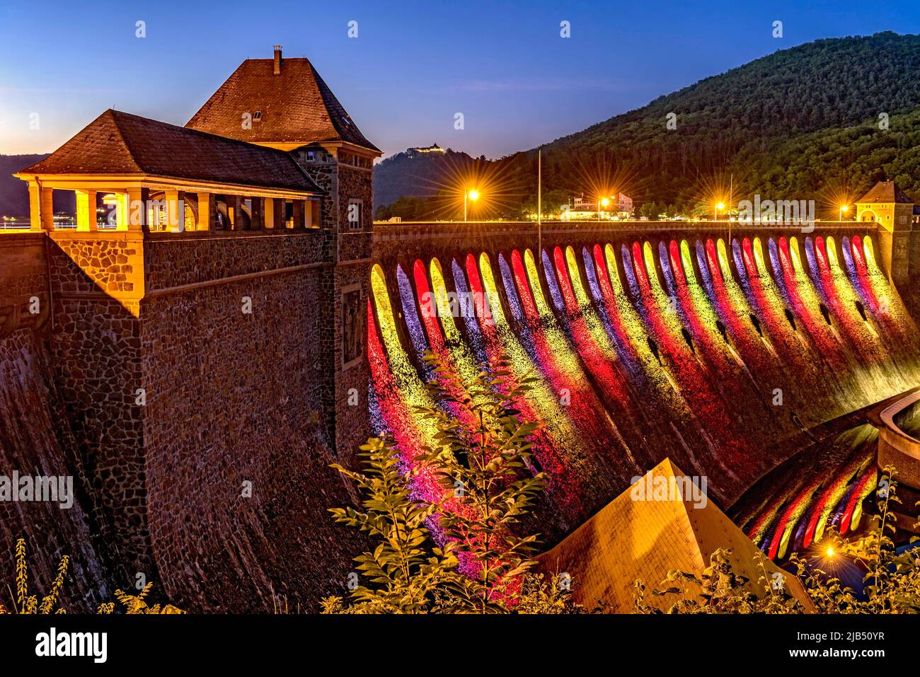 Dam in the evening light, illuminated in red, yellow and blue, dam wall ...