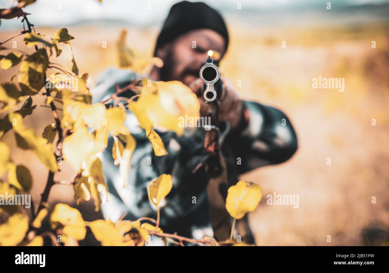 Hunter aiming rifle in forest. Autumn hunting season. Hunter with ...