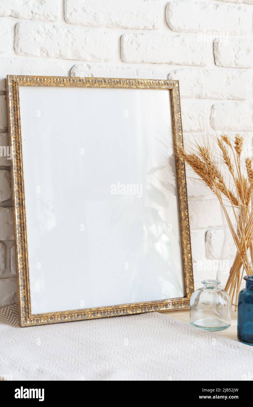 Vase with ears of wheat and photo frames against brick wall Stock Photo ...