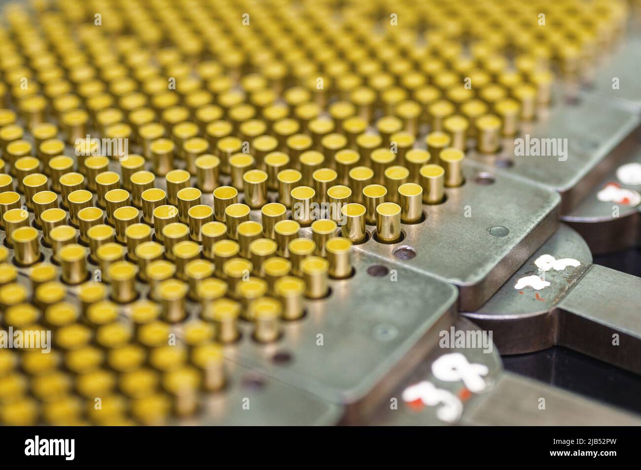 Set of golden bullet shells in metal cartridges on stand Stock Photo ...