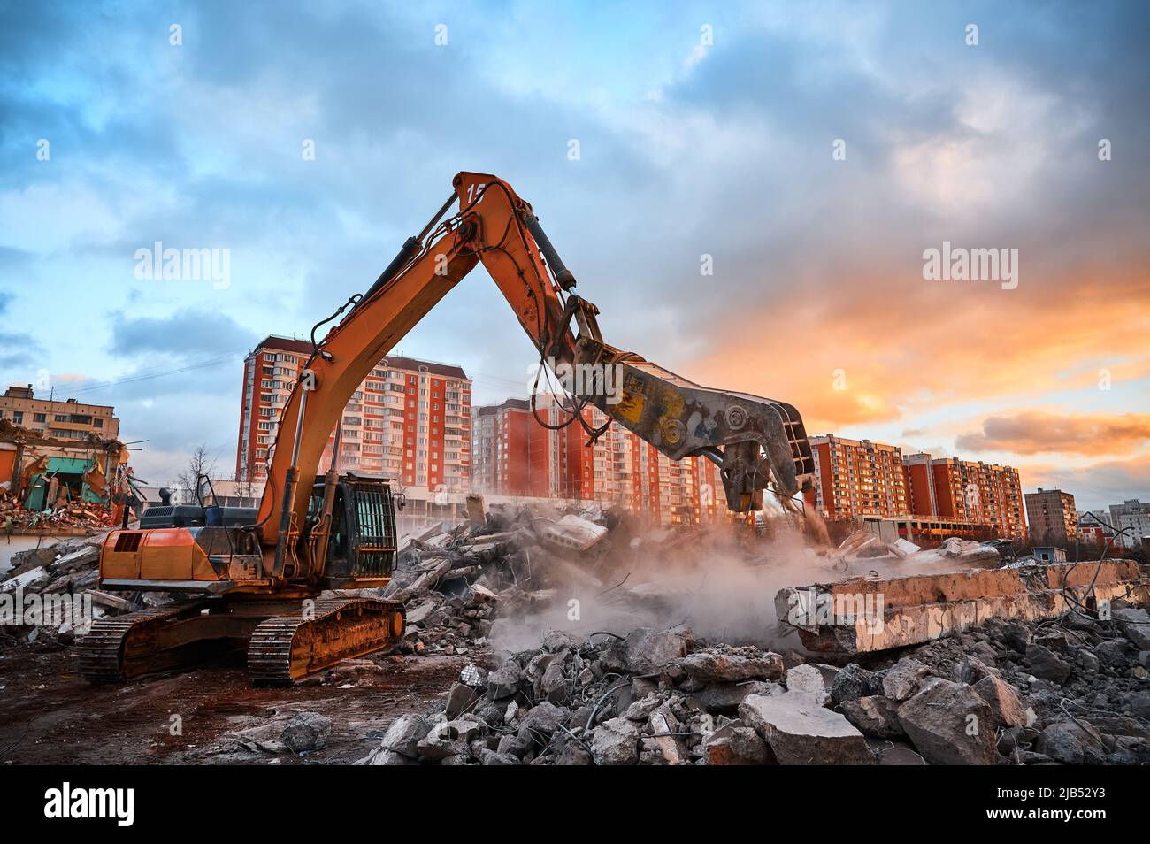Excavator with concrete crusher on rig at demolition site Stock Photo ...