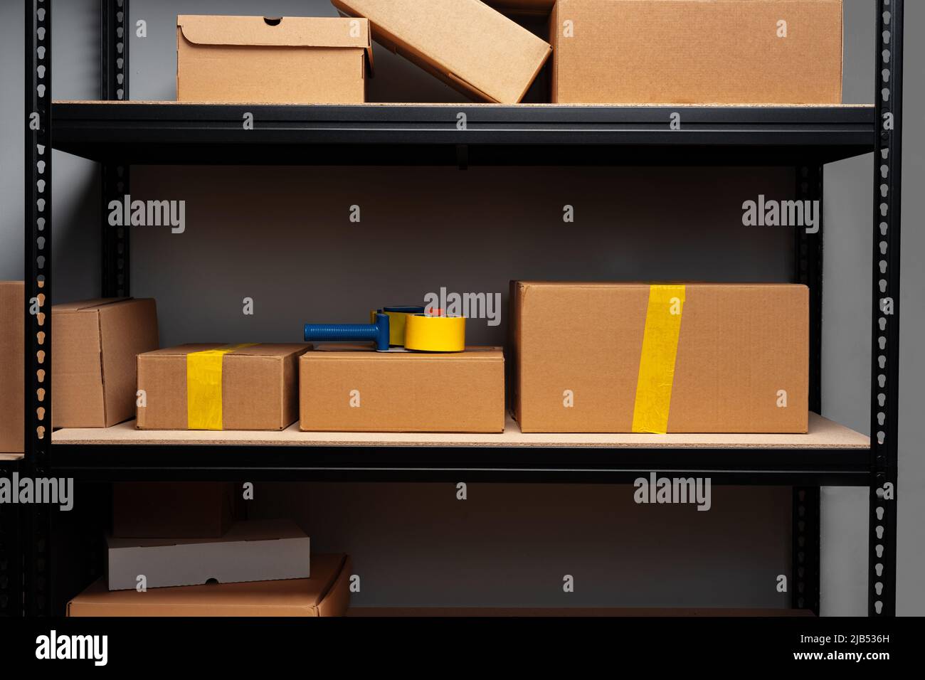 Rack shelves with paper boxes in warehouse Stock Photo - Alamy