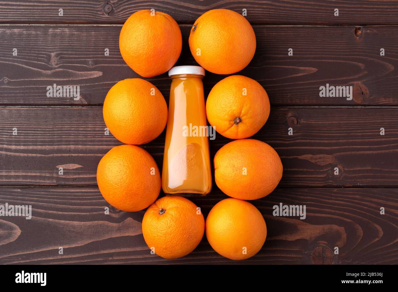 Fresh orange juice in the glass with orange fruit on wooden background ...