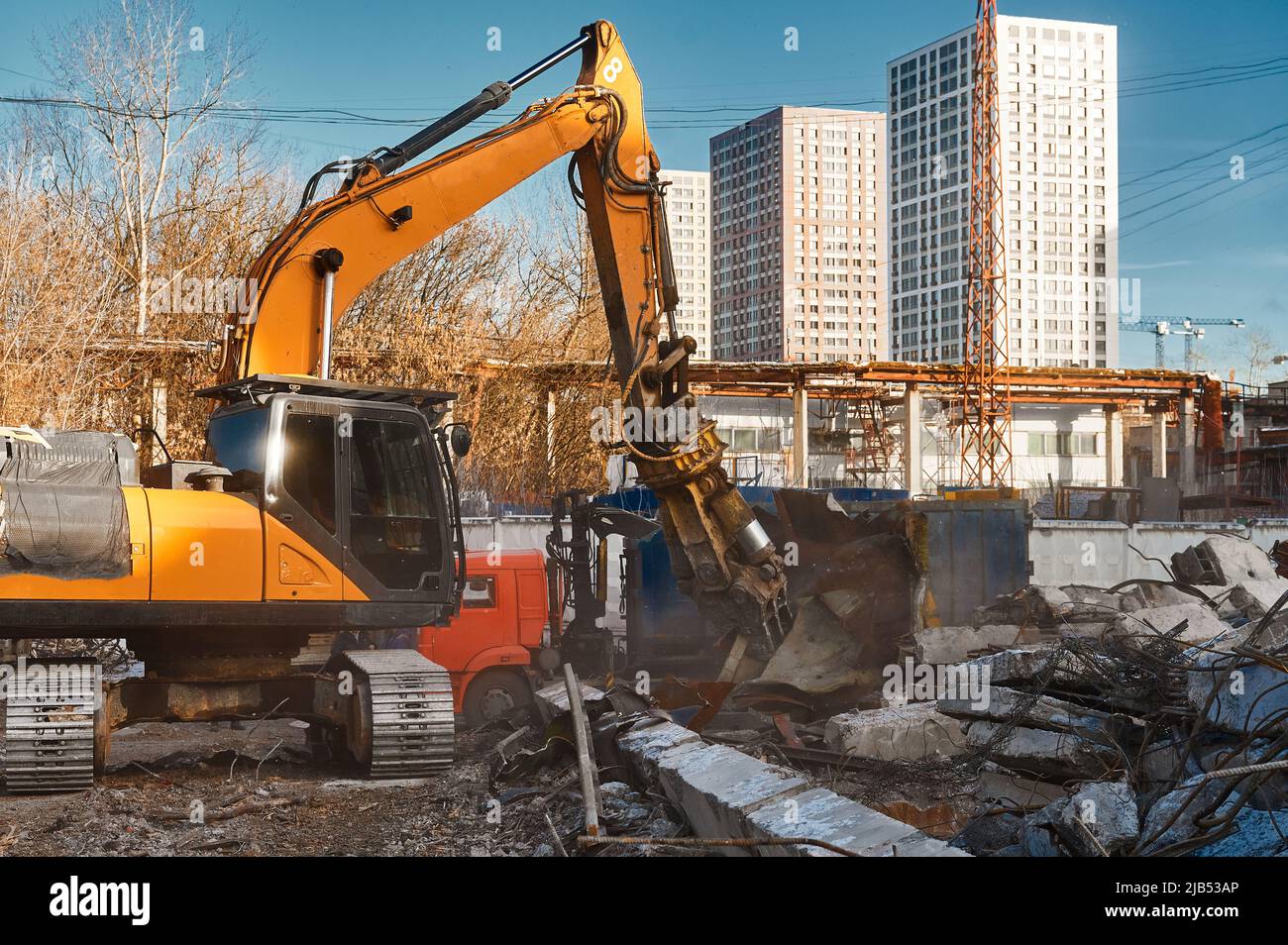 Excavator destroyer removes debris Building demolition Stock Photo - Alamy