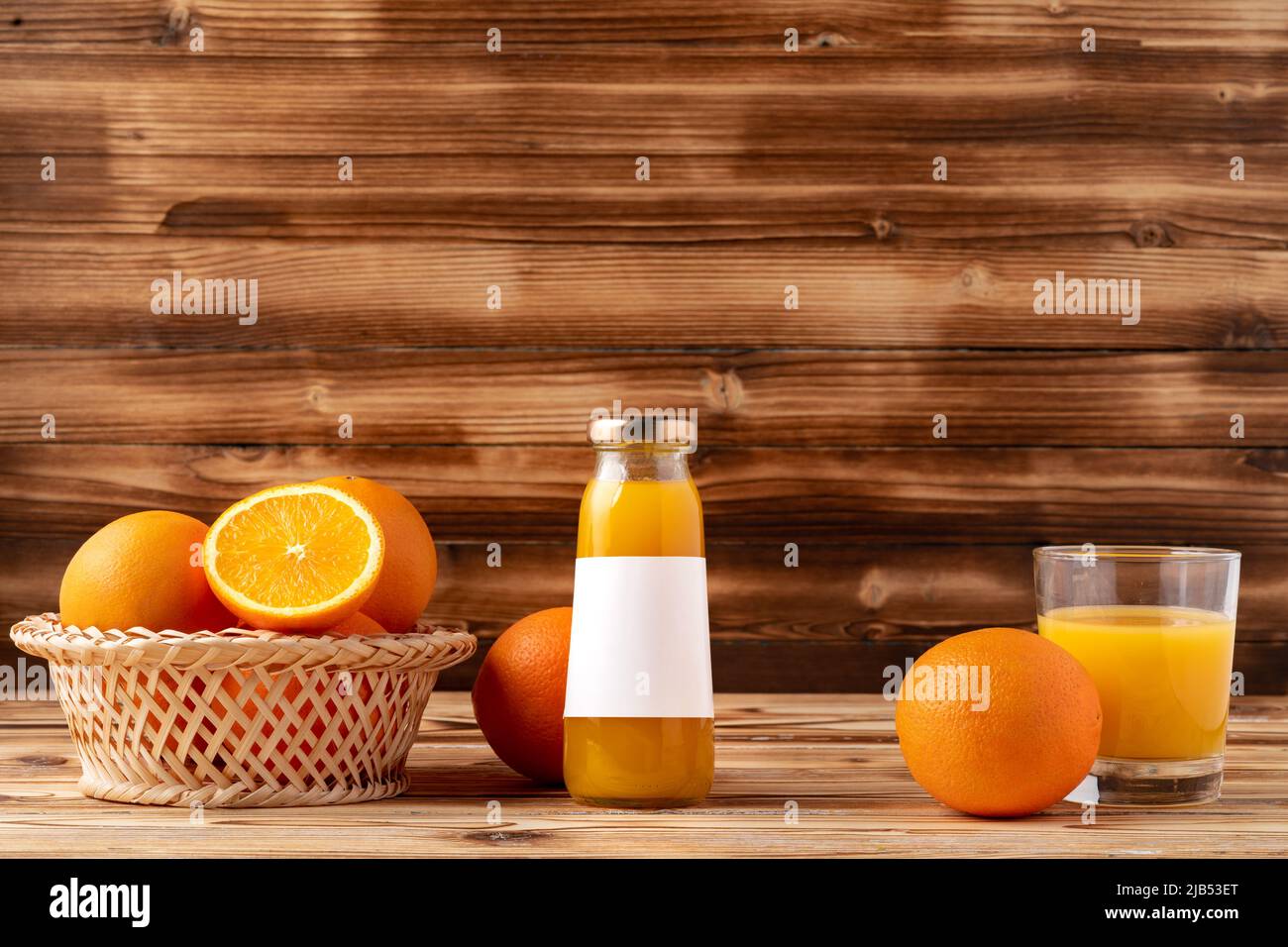 Orange fruit and orange juice on wooden background Stock Photo - Alamy