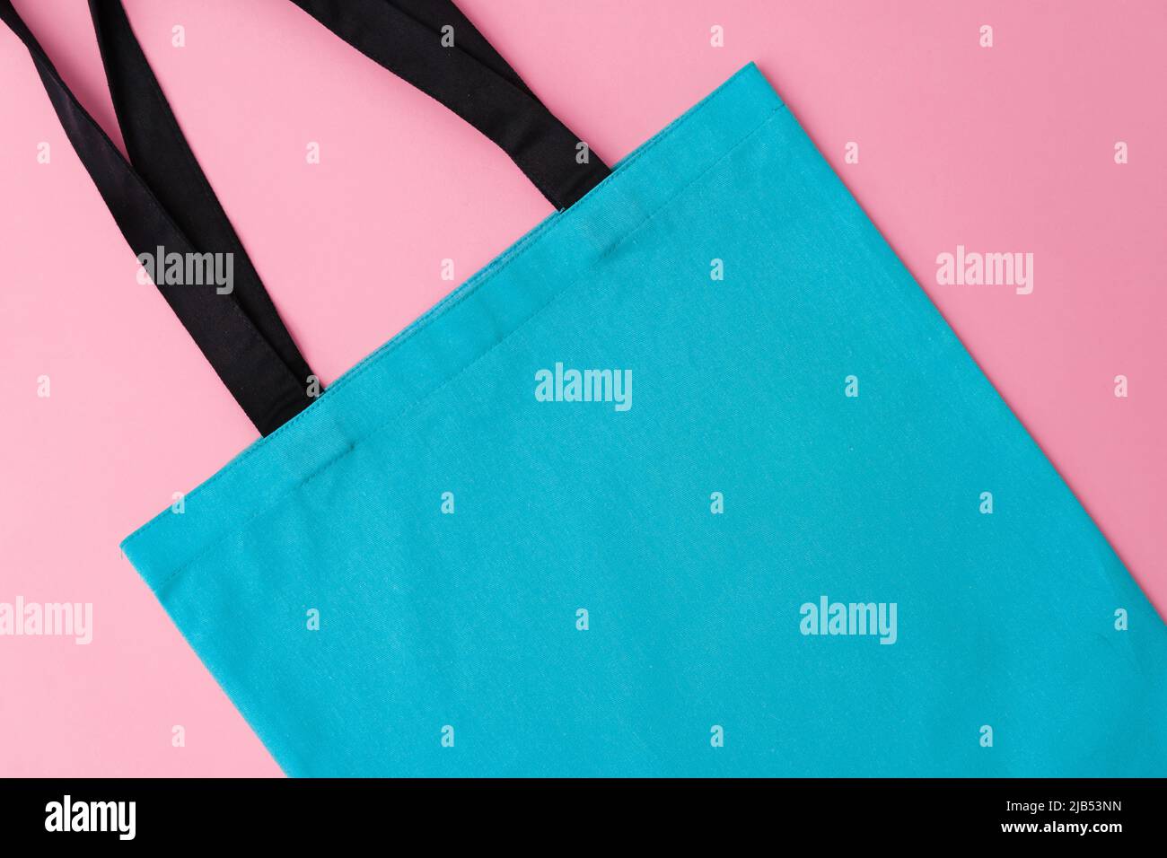 Textile shopping bag on pink paper background flat lay Stock Photo - Alamy