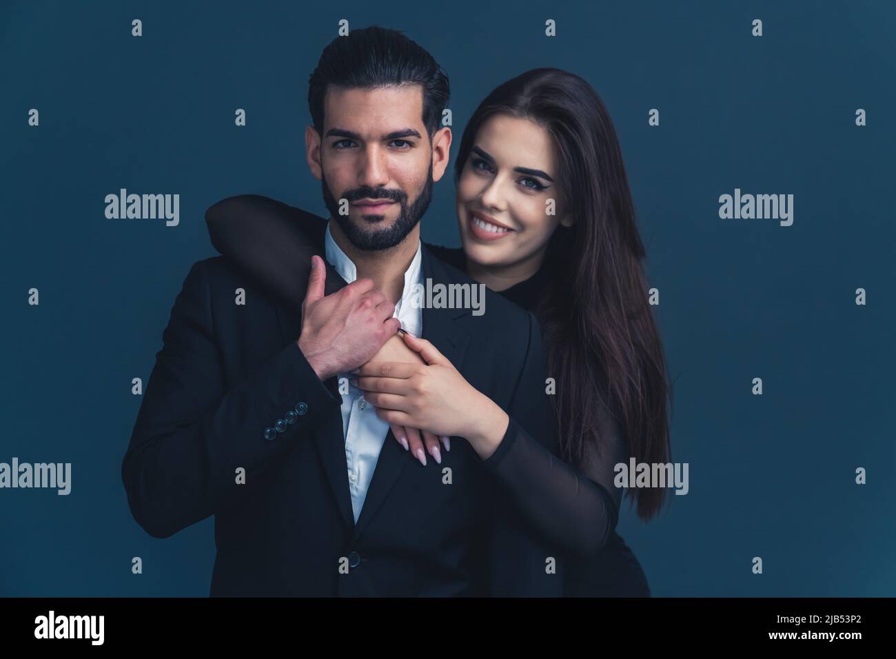 Neat elegant couple portrait. Long-haired beautiful woman in her 20s ...