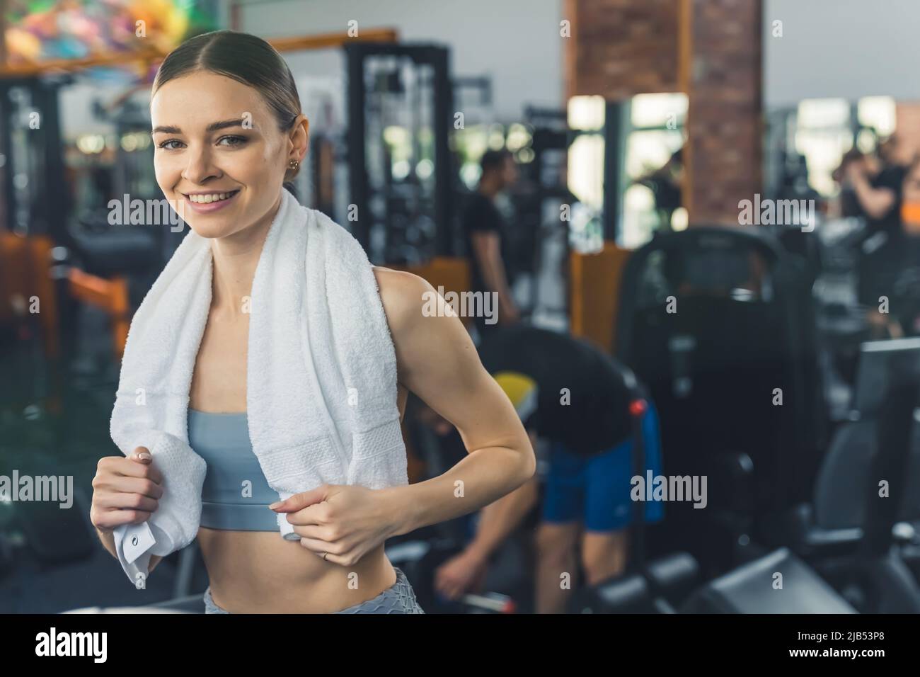 Indoor portrait of happy cheerful white woman in sportswear with white ...