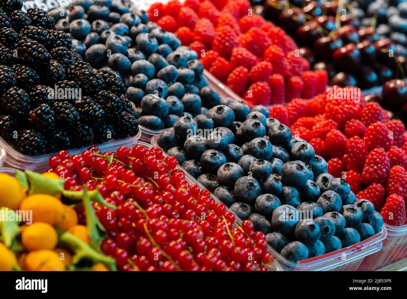 Colorful fruit berries are displayed in a market Stock Photo - Alamy