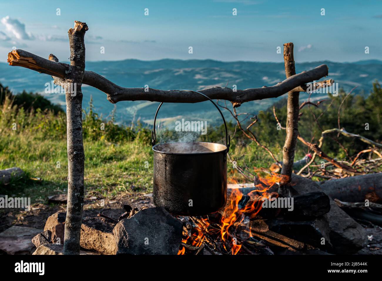 On the fire cauldron. Preparing food at the campsite. View of the ...