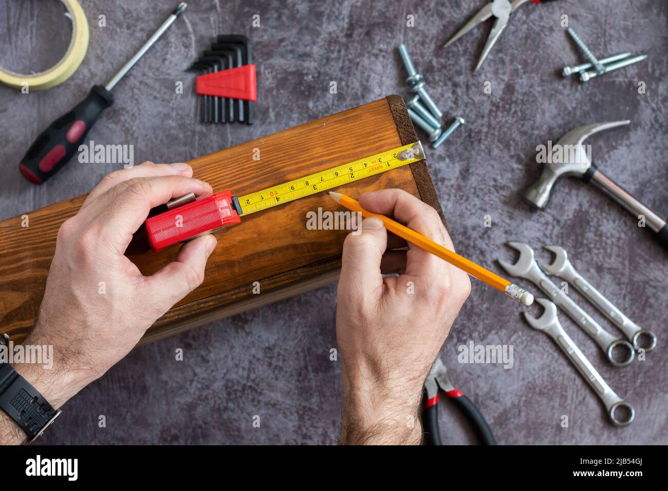 Measurements using roulette sizes for repair. Hands with tool. Set of ...