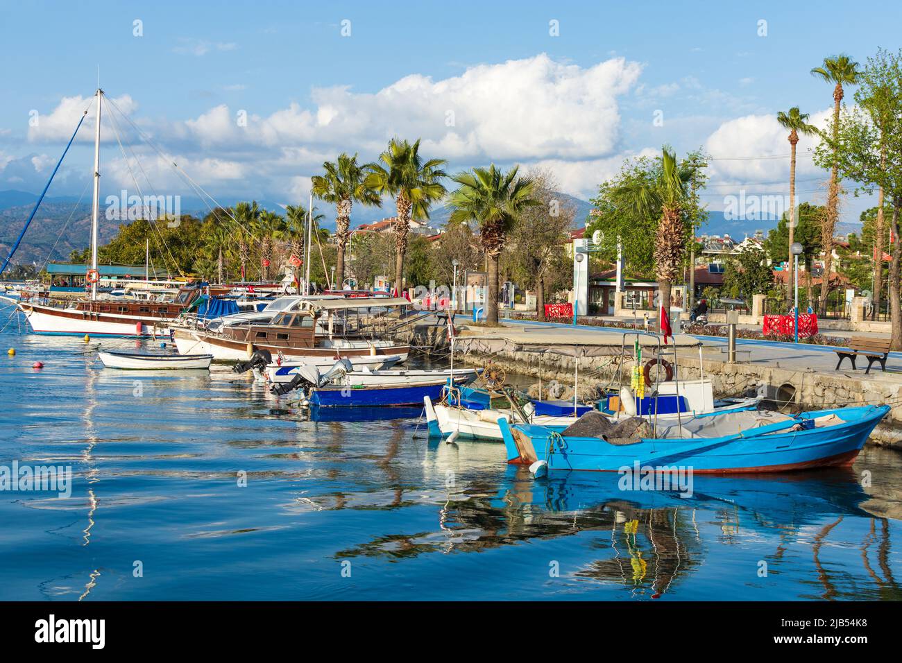 The promenade of the city of Fethiye, boats are at bay in the blue ...