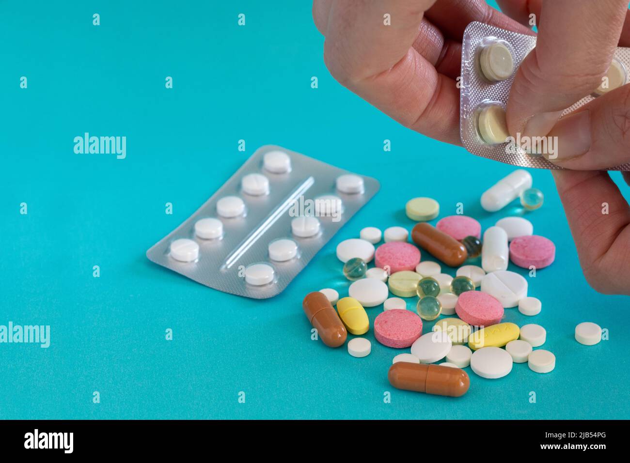 Get the pills out of the blister. Pill in hand. Pills and pills on a ...