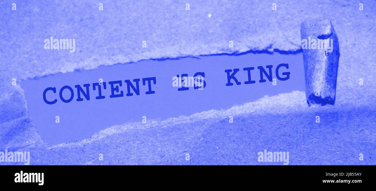 Content is king -message written under torn paper. Corywriting ...