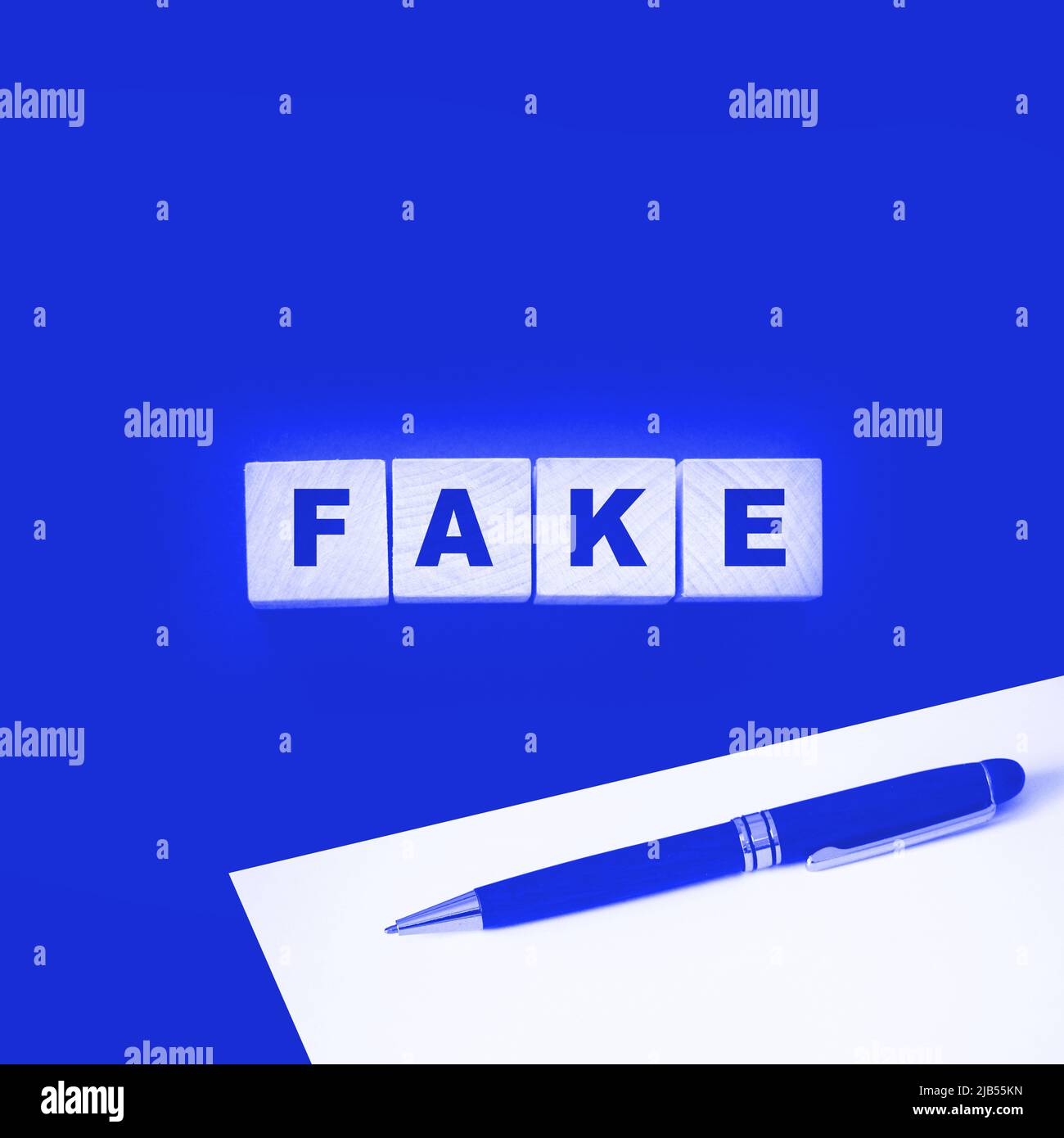 FAKE word written in wooden blocks on black background Stock Photo - Alamy