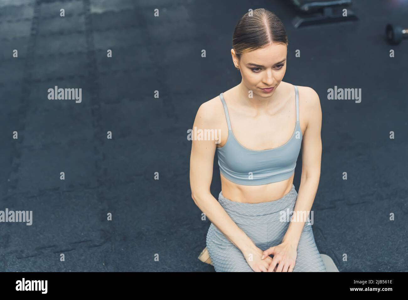 Caucasian calm focused woman in her 20s looking ahead, sitting on the ...