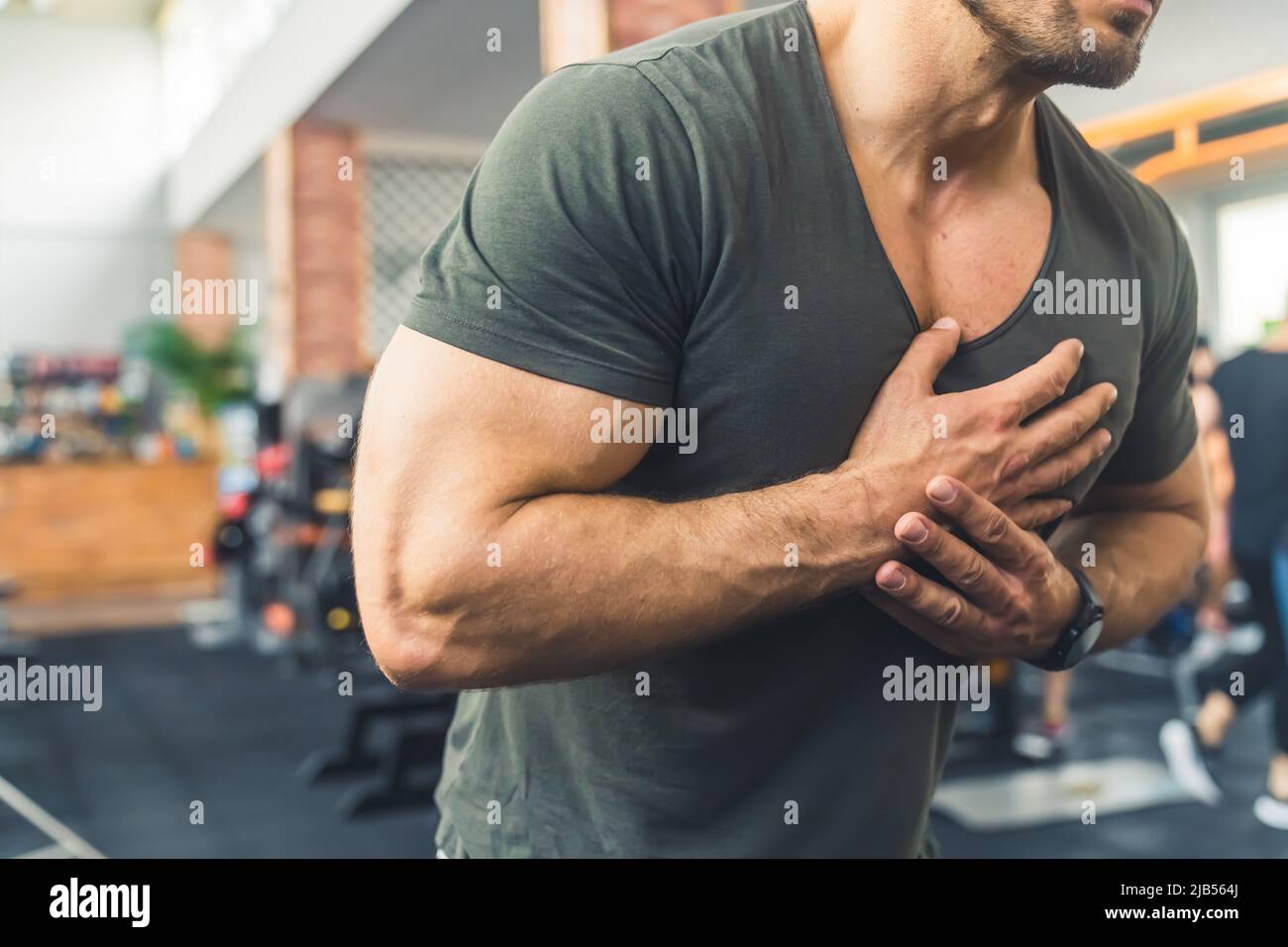 Headless shot at a gym of a bearded caucasian middle-aged man in a ...