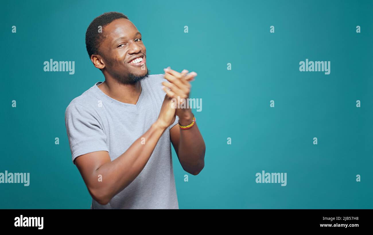 Pleased man applauding success and expressing admiration, showing ...