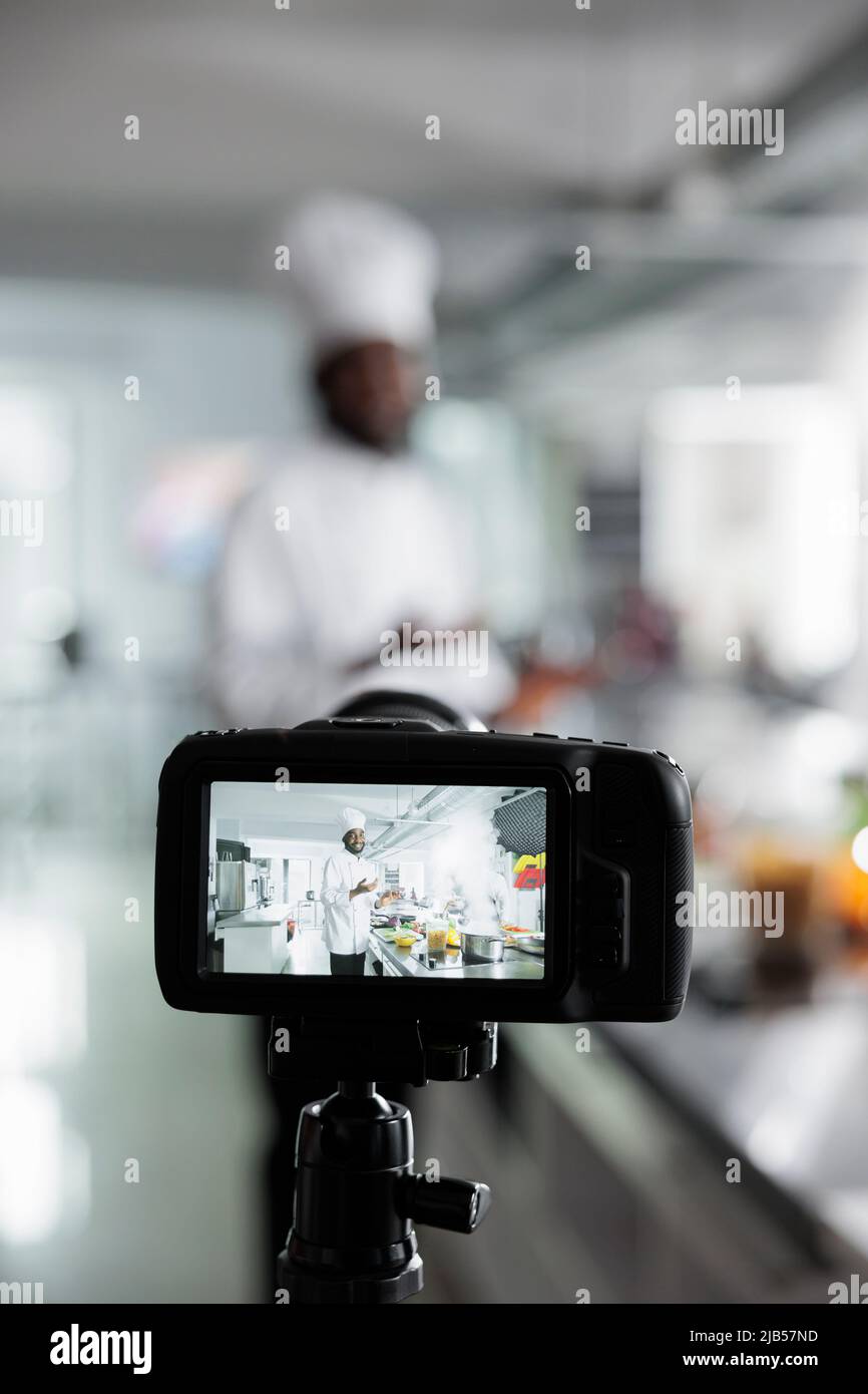 Close up of camera recording head cook preparing gourmet dish for ...