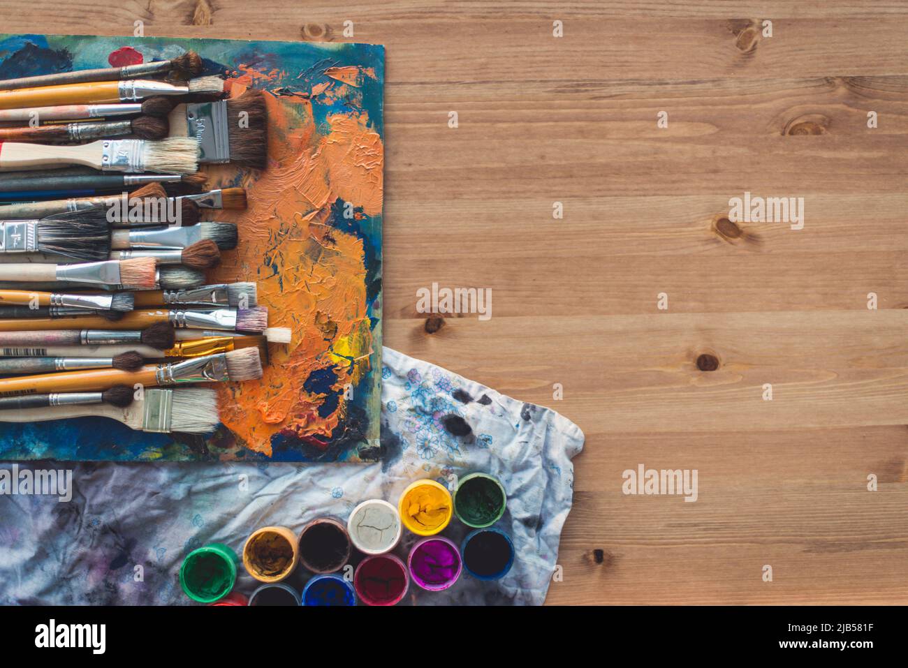 Different size paintbrush collection on an old palette with oil paint ...