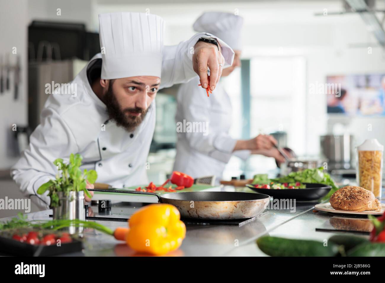 Food industry worker cooking delicious gourmet dish for dinner service ...