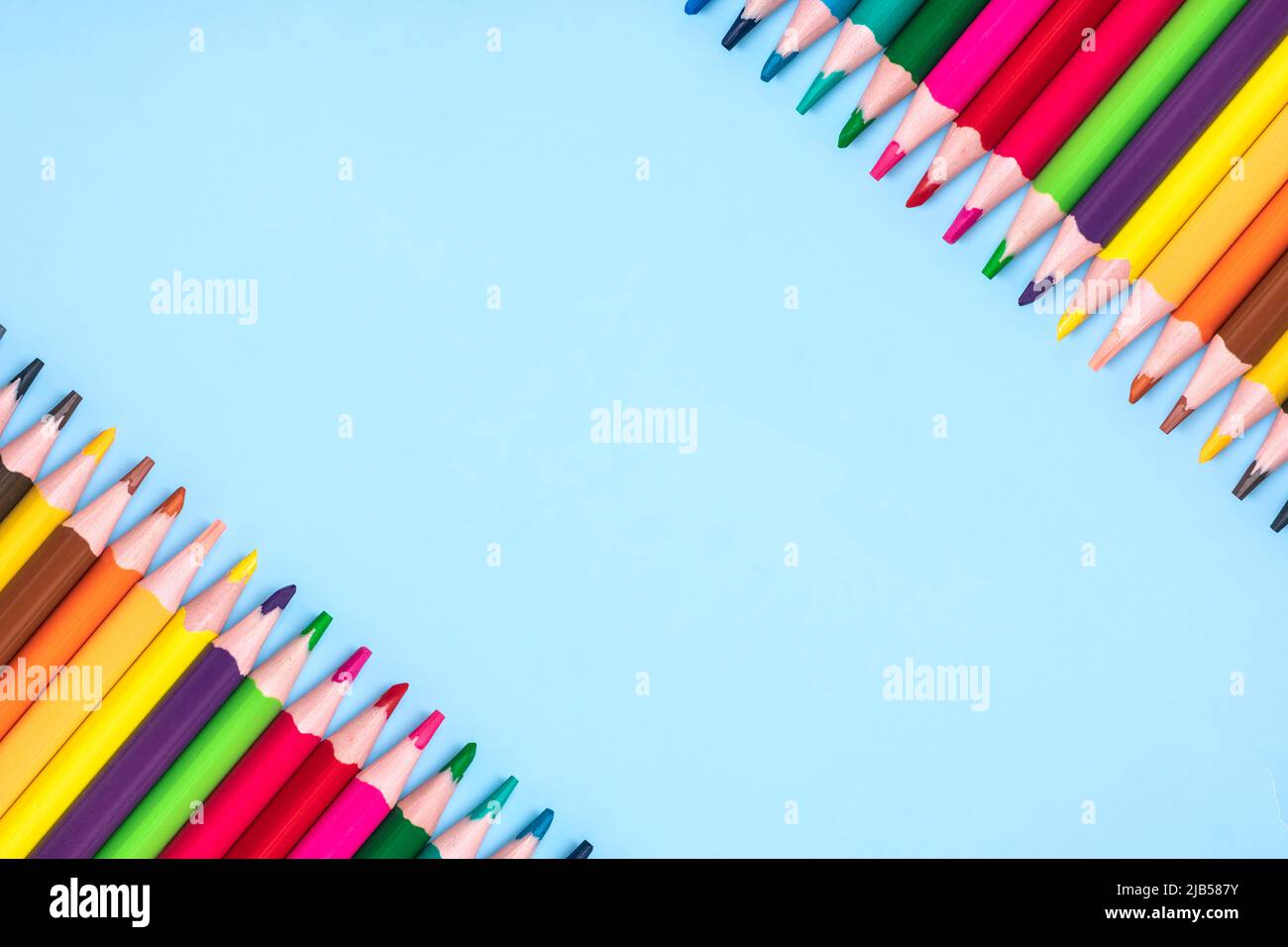 set of colored pencils isolated on blue background Top view Flat lay ...