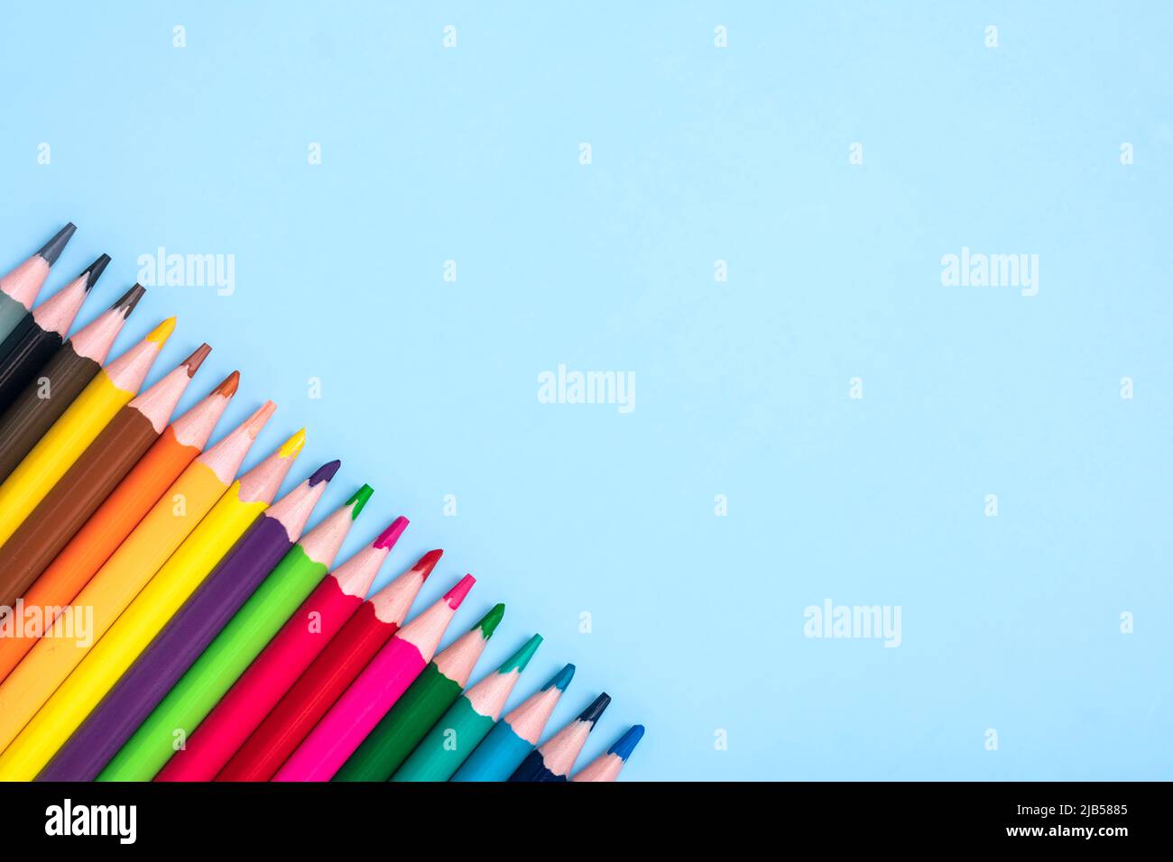 set of colored pencils isolated on blue background Top view Flat lay ...