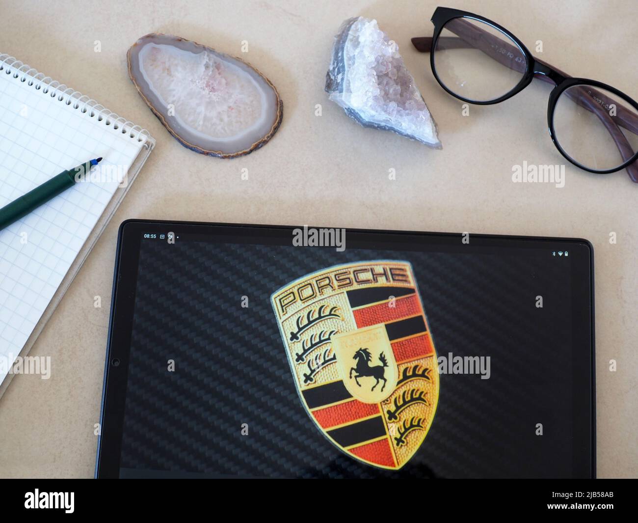 In this photo illustration Porsche AG logo seen displayed on a tablet ...